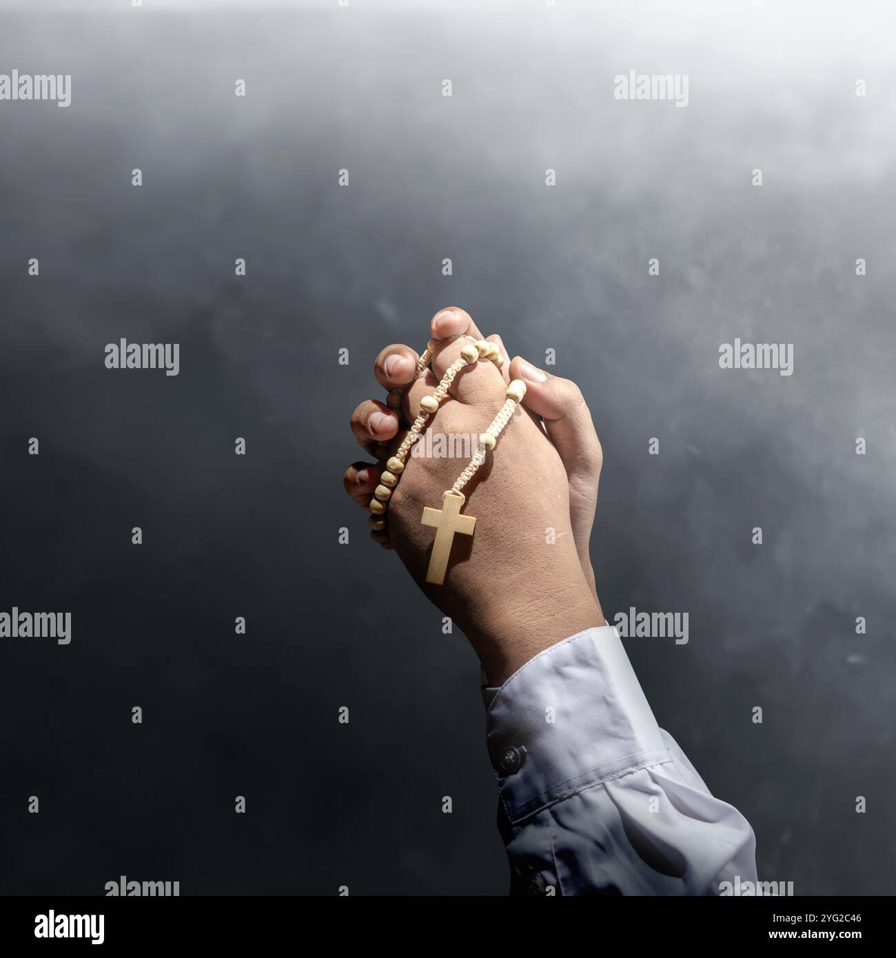 Man raised hand while holding a rosary beads. Symbol of faith and ...
