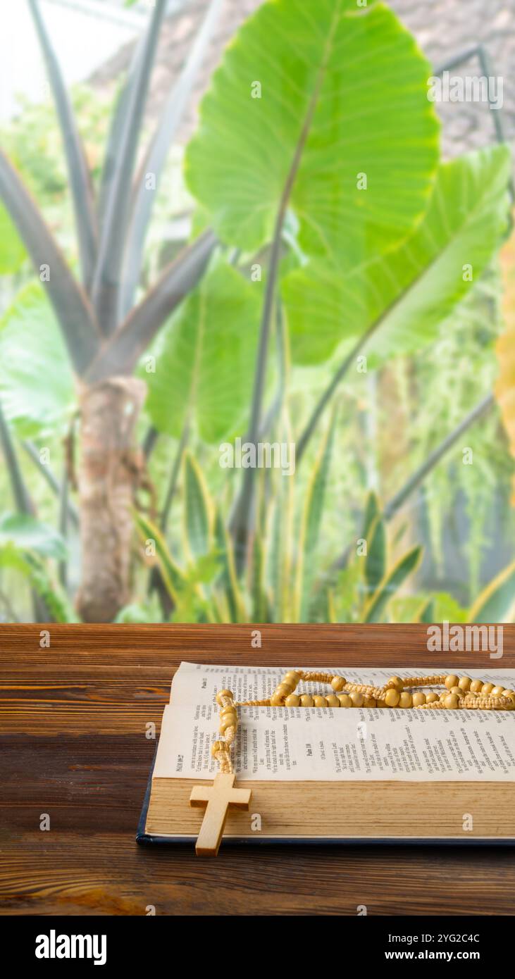 Opened book of Holy Bible with rosary beads. Symbol of faith and ...