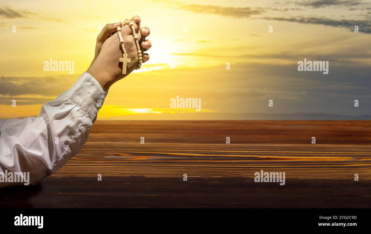 Man raised hand while holding a rosary beads. Symbol of faith and ...