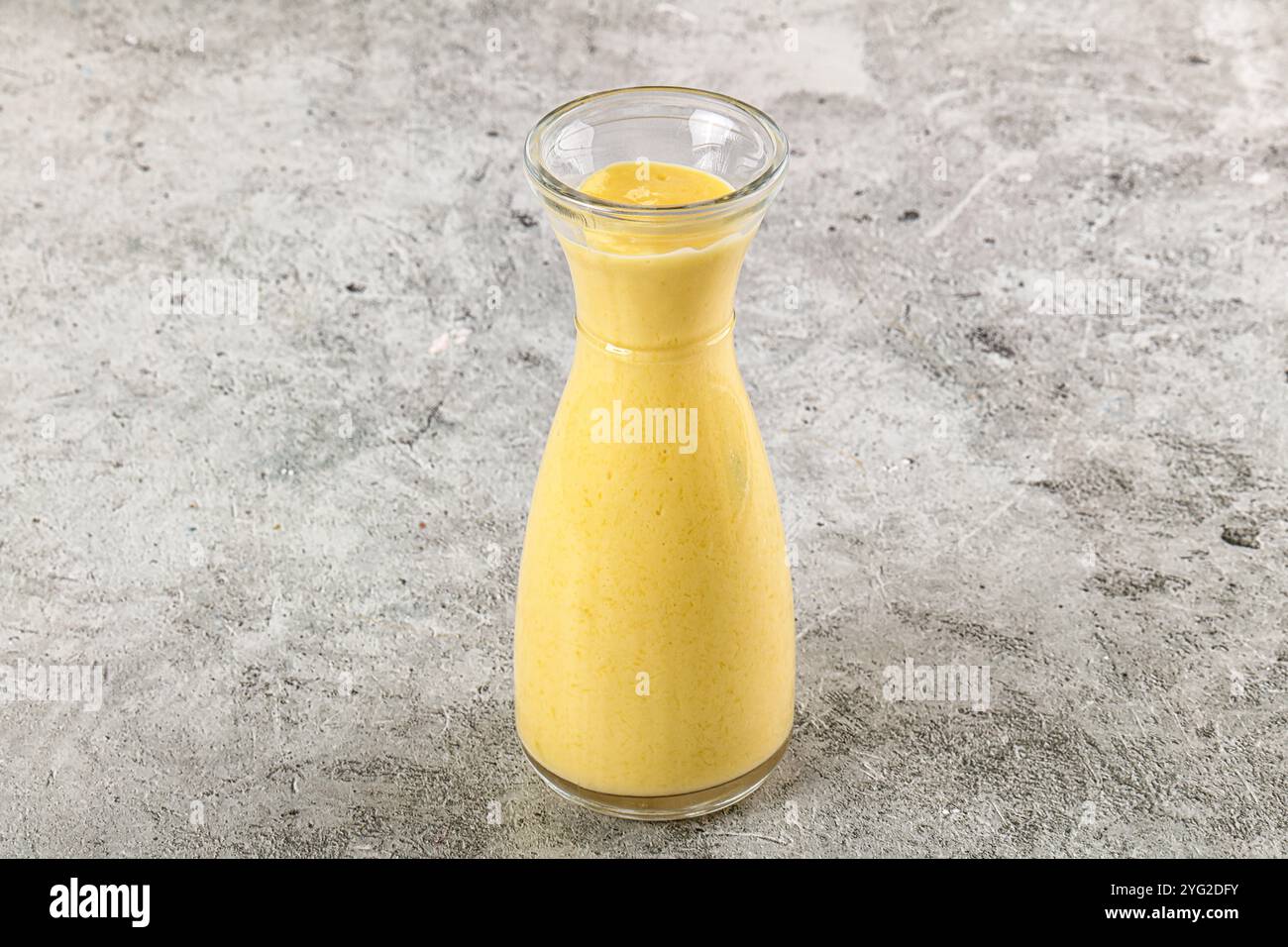 Cold sweet mango smoothie glass with ice Stock Photo - Alamy