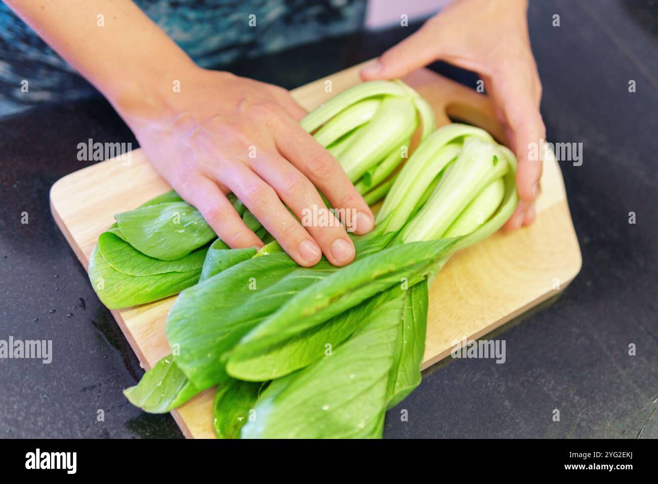 Green bok choy on a cutting board in a kitchen Stock Photo - Alamy