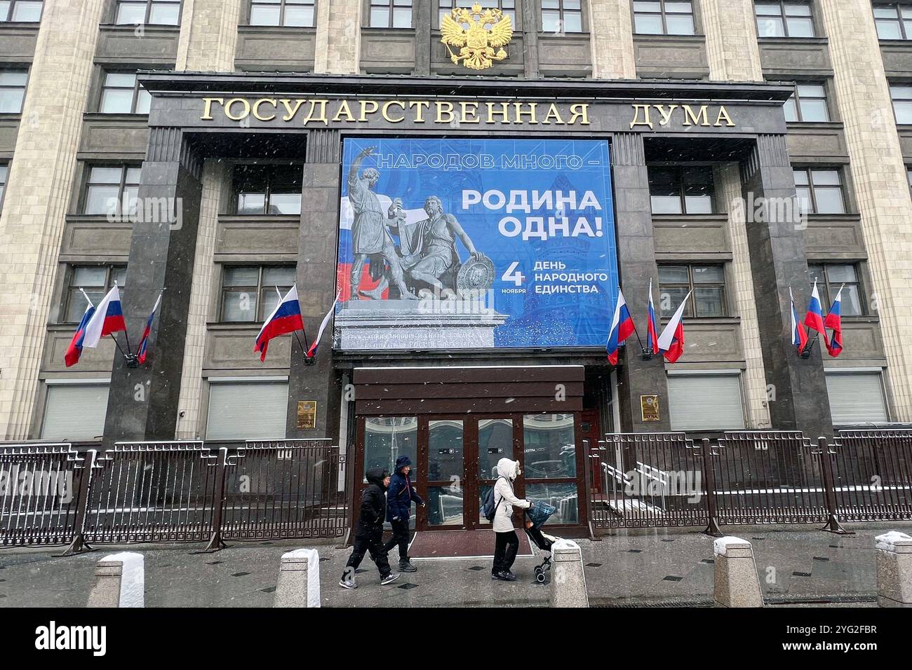 Pedestrians walk past the entrance of the Russian State Duma building ...