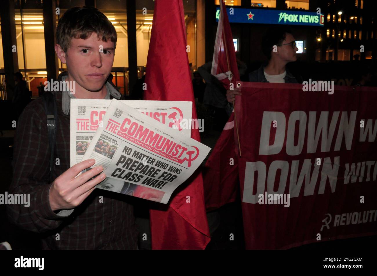 A demonstrator of the group, Revolutionary Communists of America, holds ...