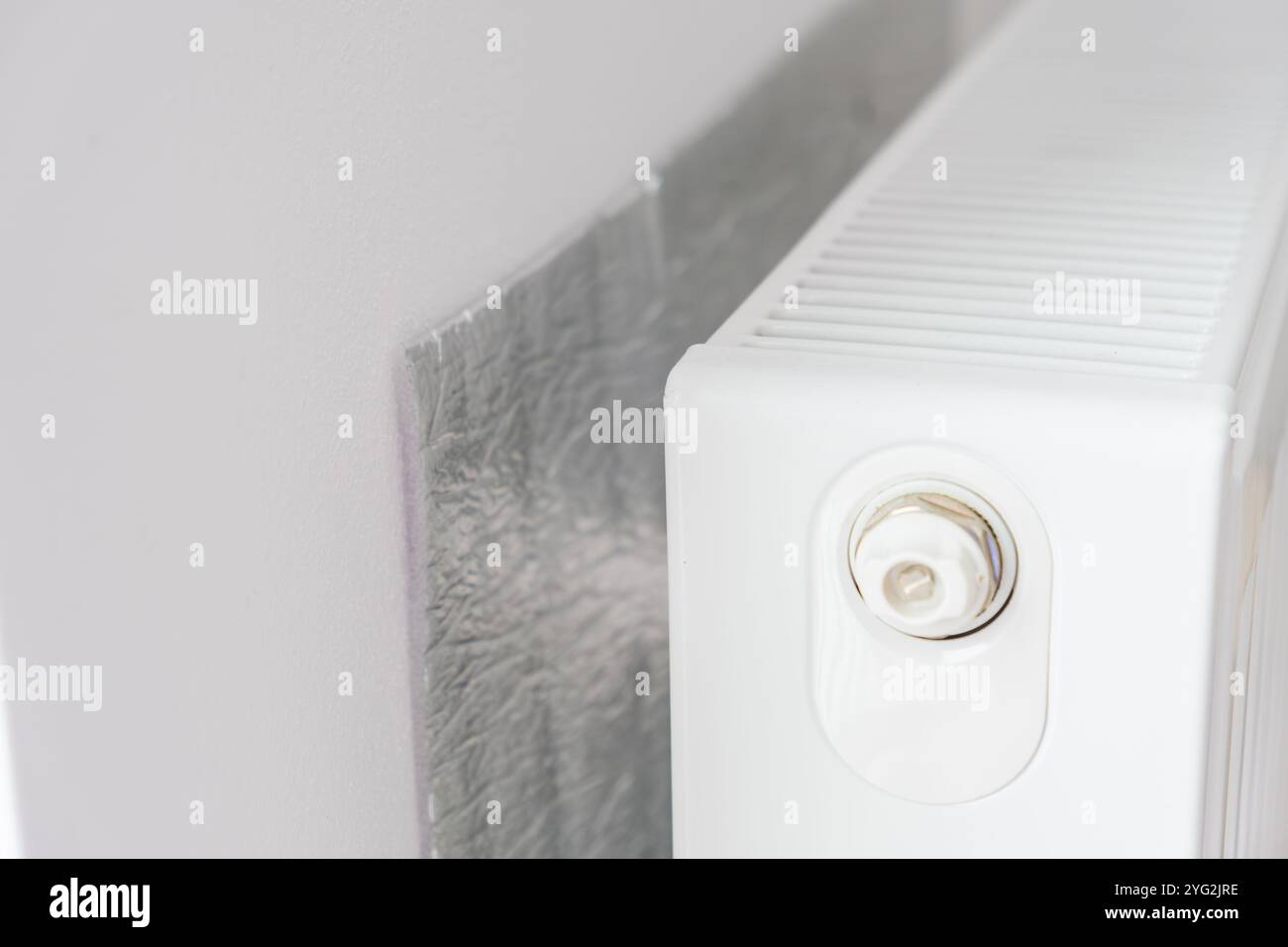 Thermal insulation panel positioned behind radiator to reflect heat ...