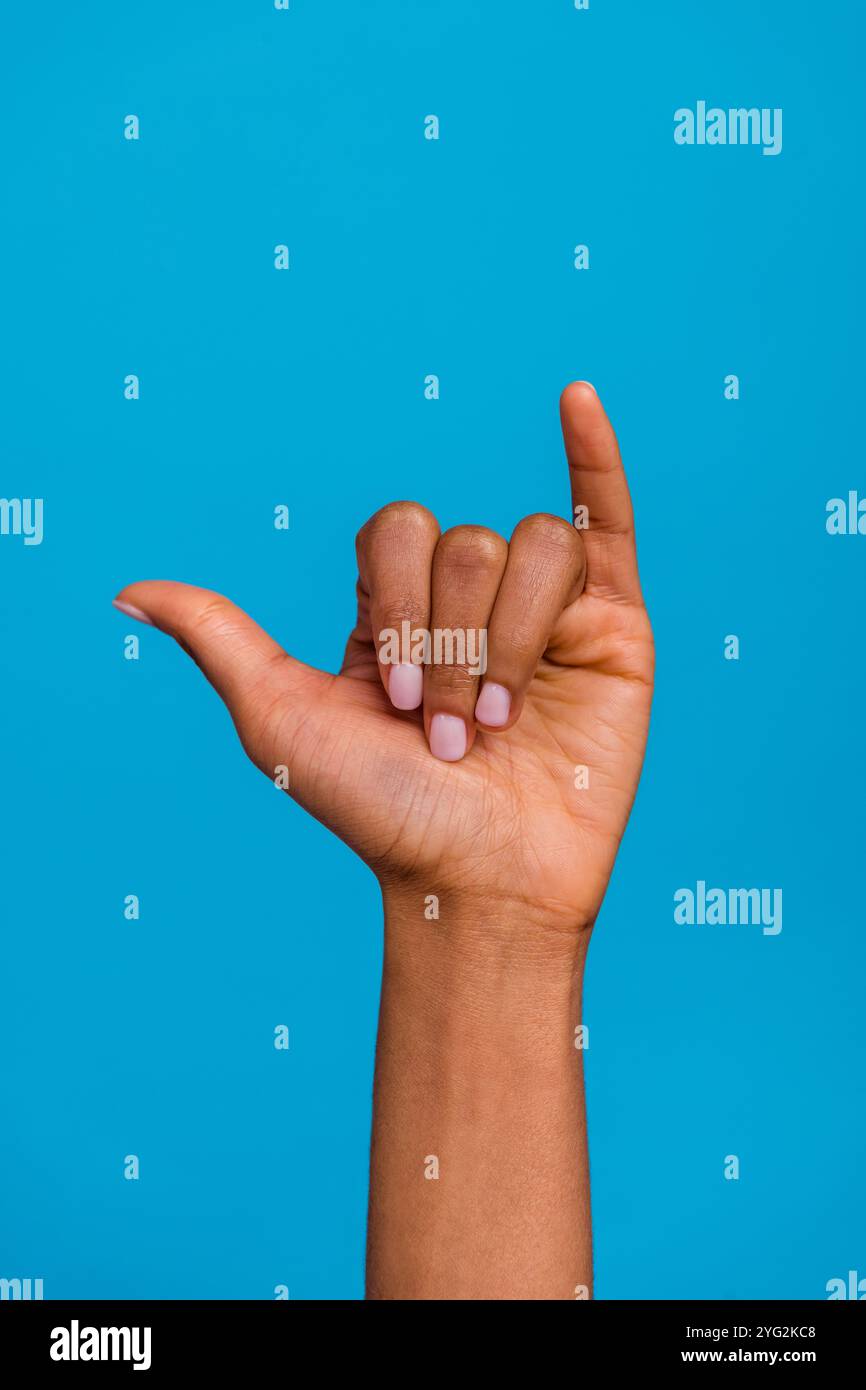 Vertical cropped view of attractive girl hand showing drink symbol ...