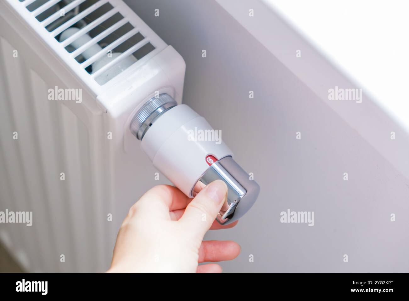 Hand adjusting radiator valve to control room heating temperature Stock ...
