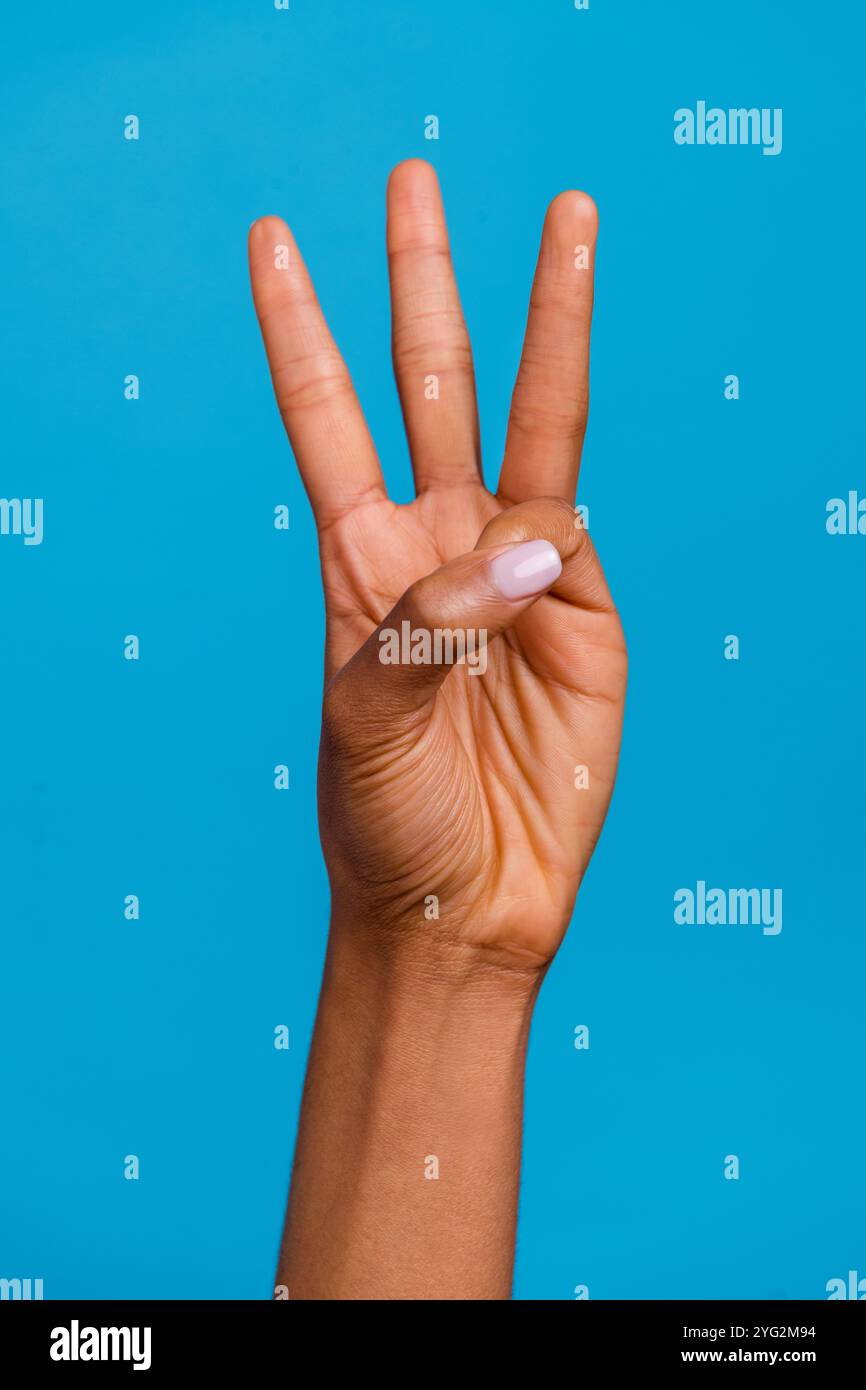 Vertical cropped closeup view of attractive girl hand showing three ...