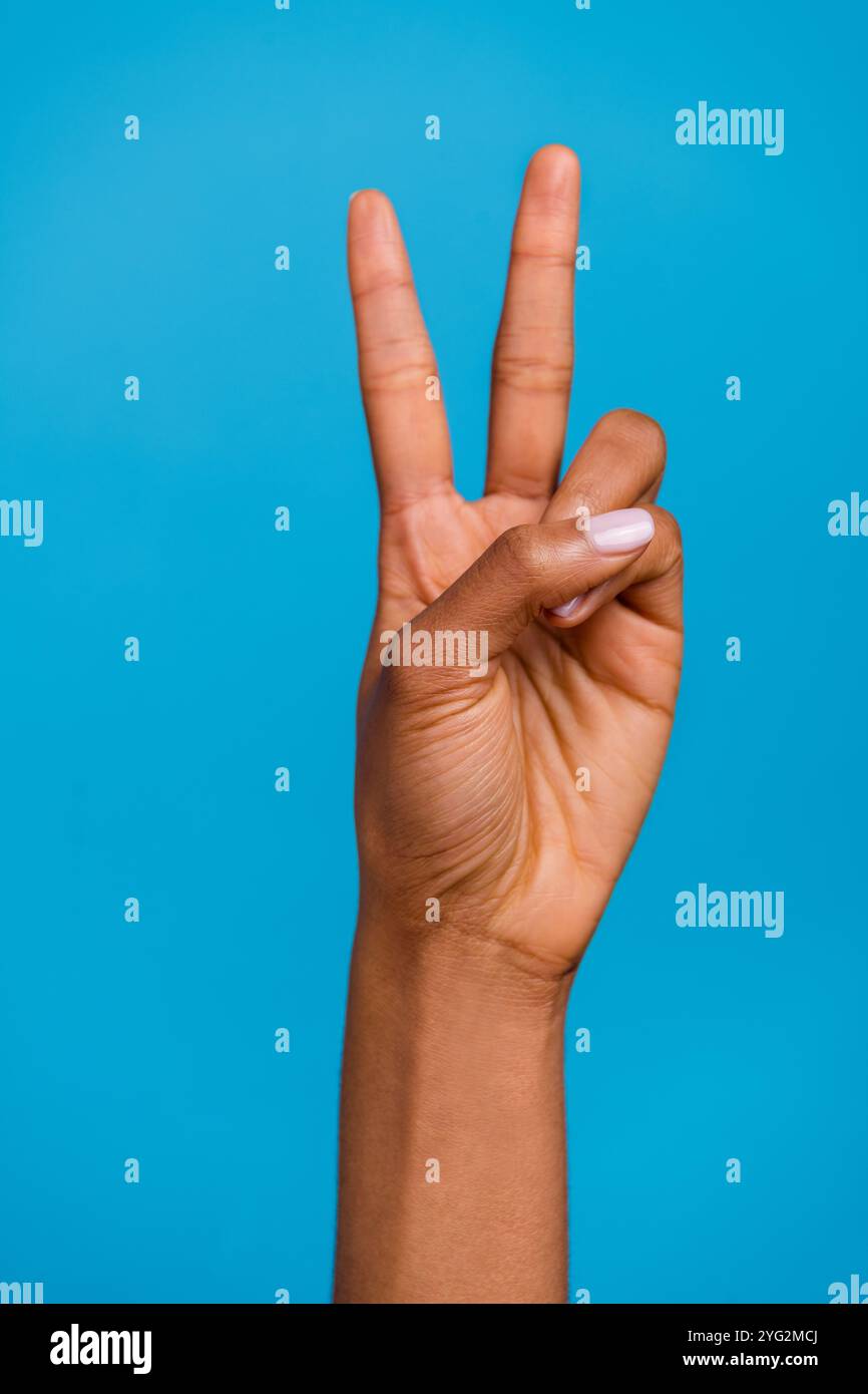 Vertical cropped closeup view of beautiful girl hand showing v-sign ...