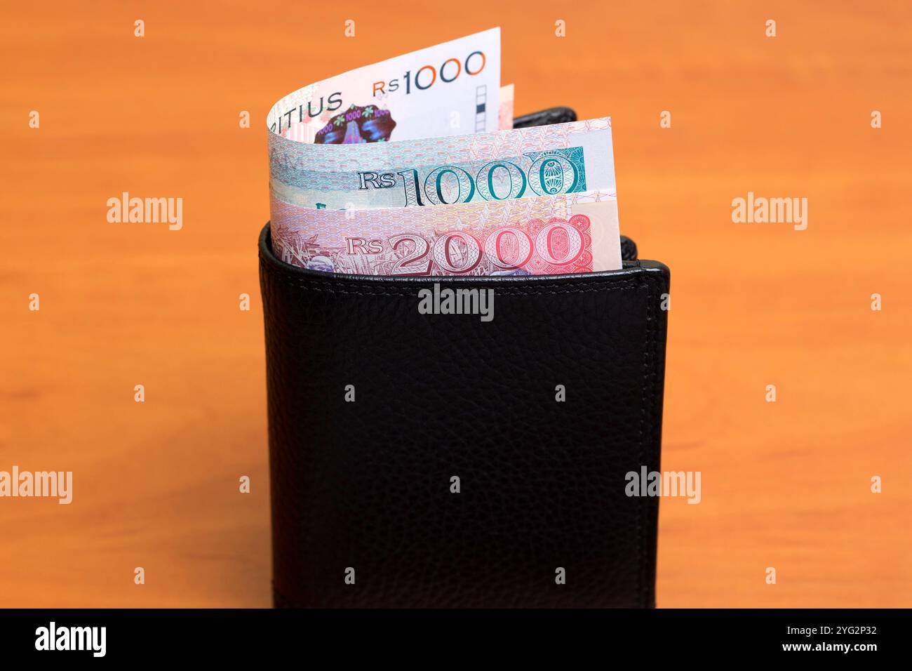 Mauritian money - rupee in the black wallet Stock Photo - Alamy