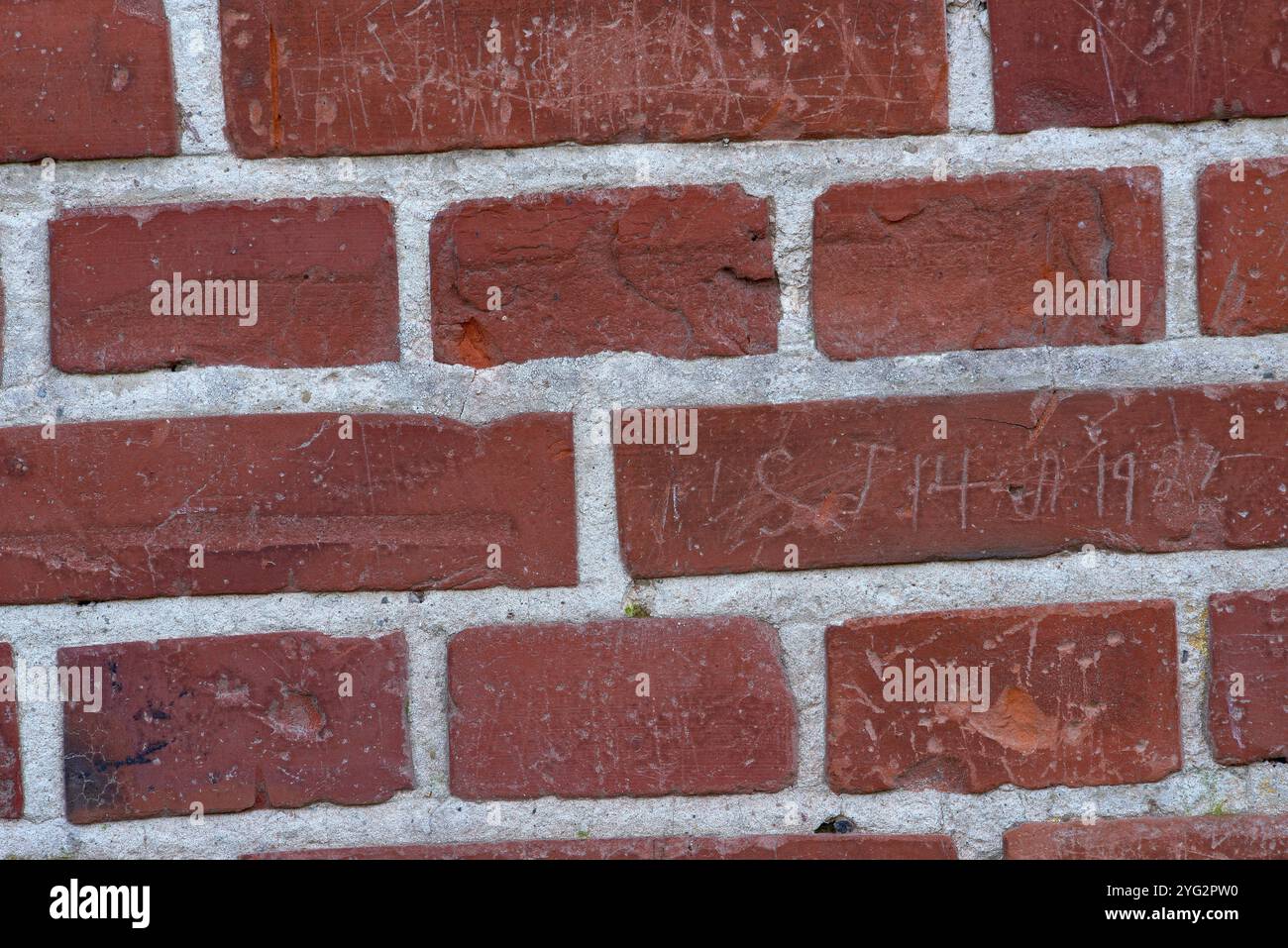 Scribble, writing and scratch on brick wall of building in city for ...