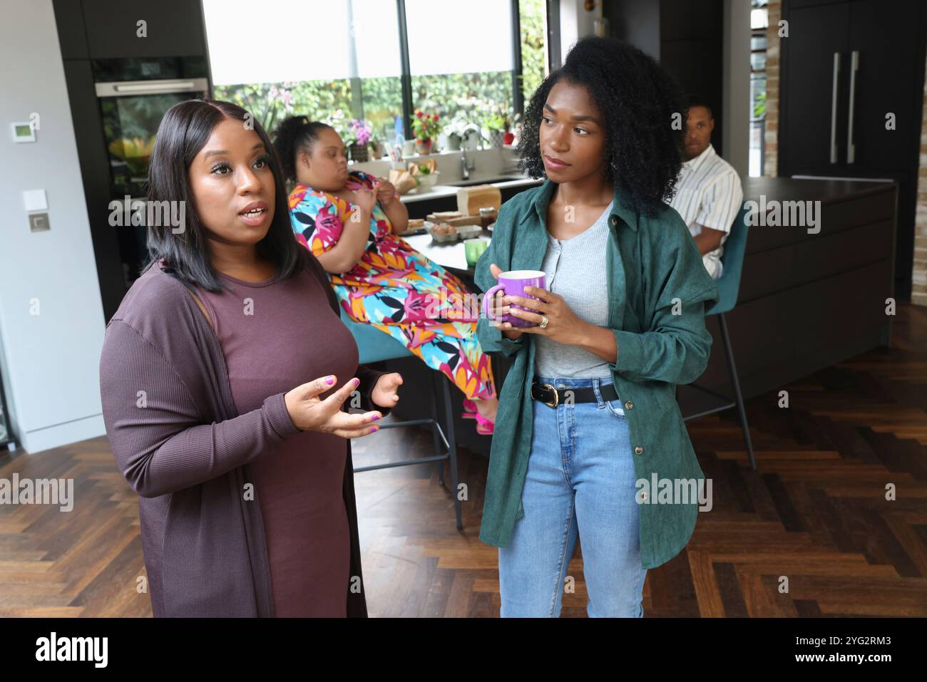 Group of people in kitchen Stock Photo - Alamy