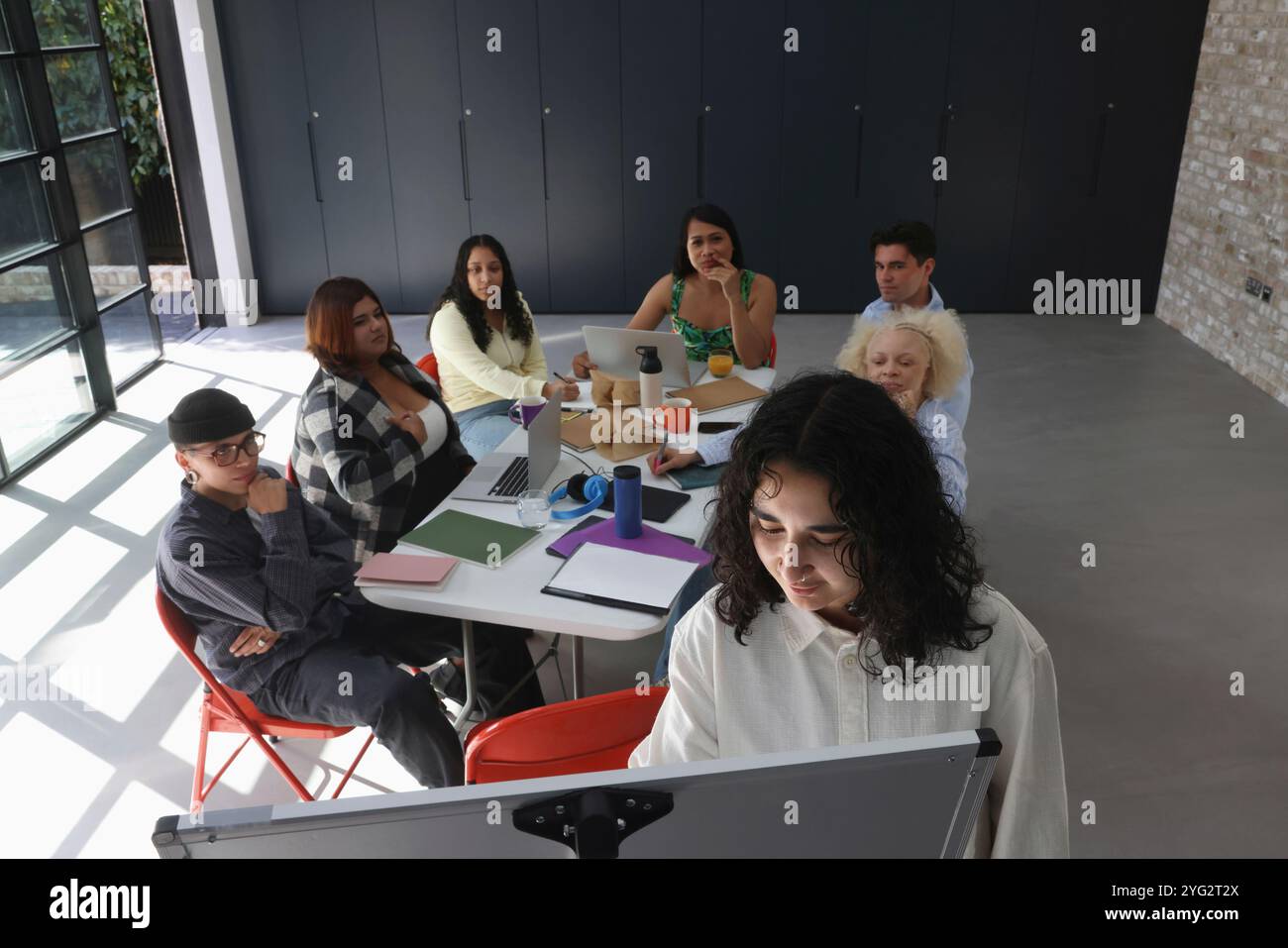 Person presenting to colleagues during business meeting Stock Photo - Alamy