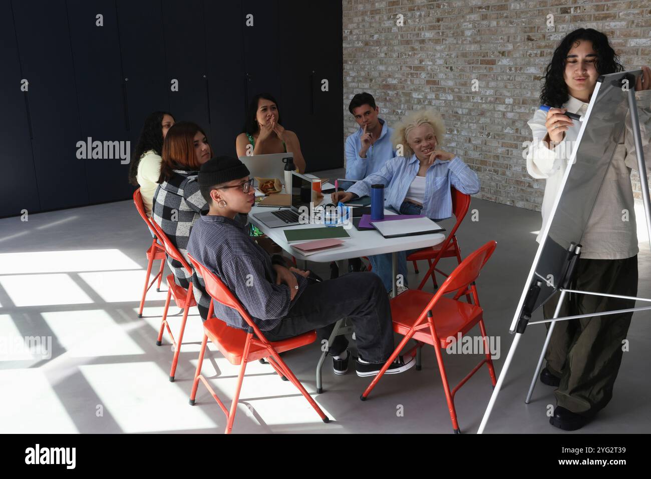 Person presenting to colleagues during business meeting Stock Photo - Alamy