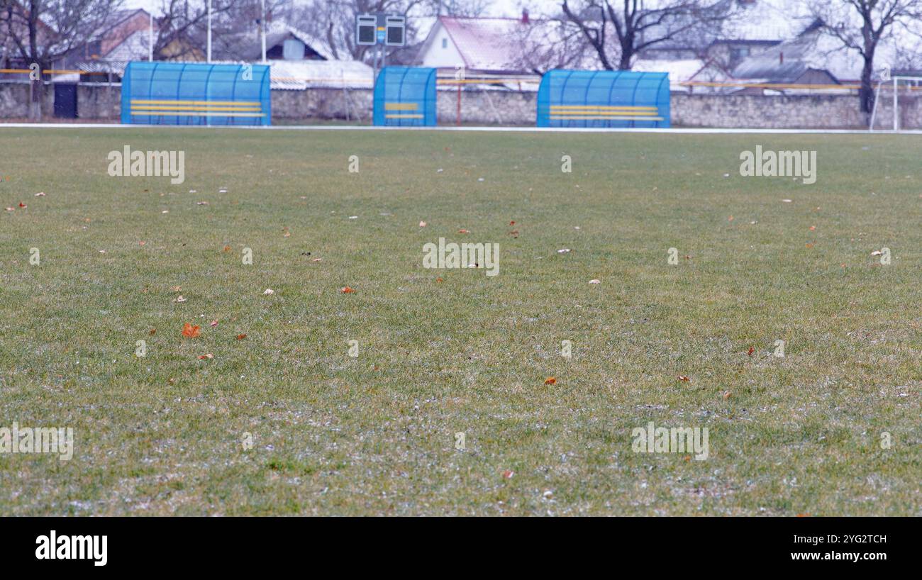 A view of an empty football field covered in grass with gates and ...