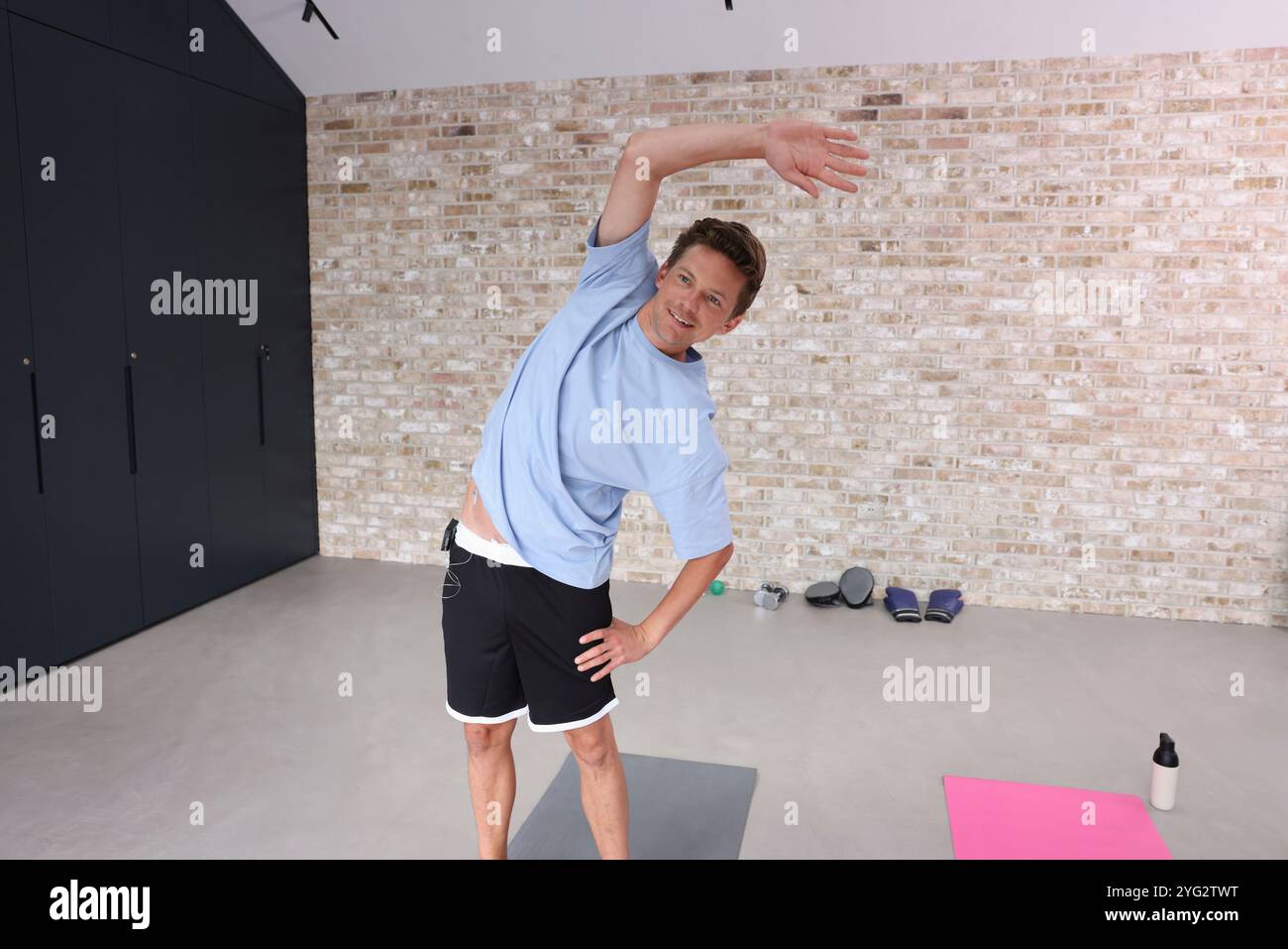 Stretching his arms hi-res stock photography and images - Alamy