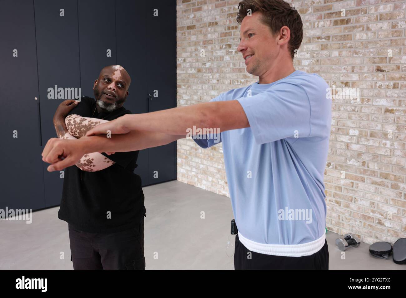 Two men stretching in hi-res stock photography and images - Alamy