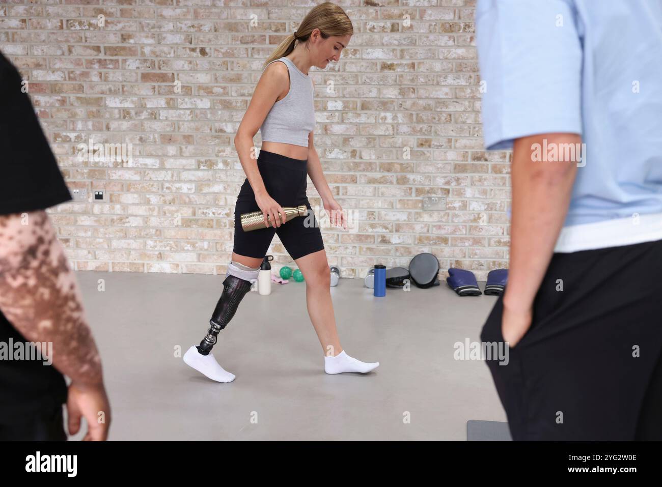 Woman with prosthetic leg showing exercise in gym Stock Photo - Alamy