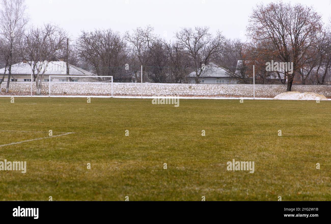 A view of an empty football field covered in grass with gates and ...