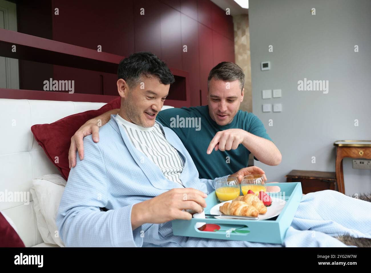 Men having breakfast on bed Stock Photo - Alamy