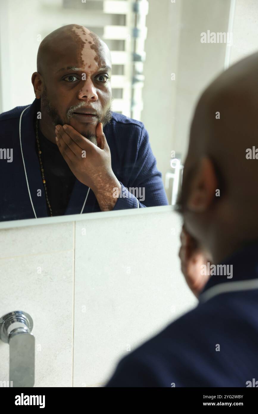 Man reflecting in bathroom mirror Stock Photo - Alamy