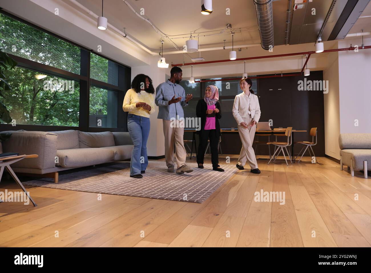 Diverse group of business people walking through office Stock Photo - Alamy