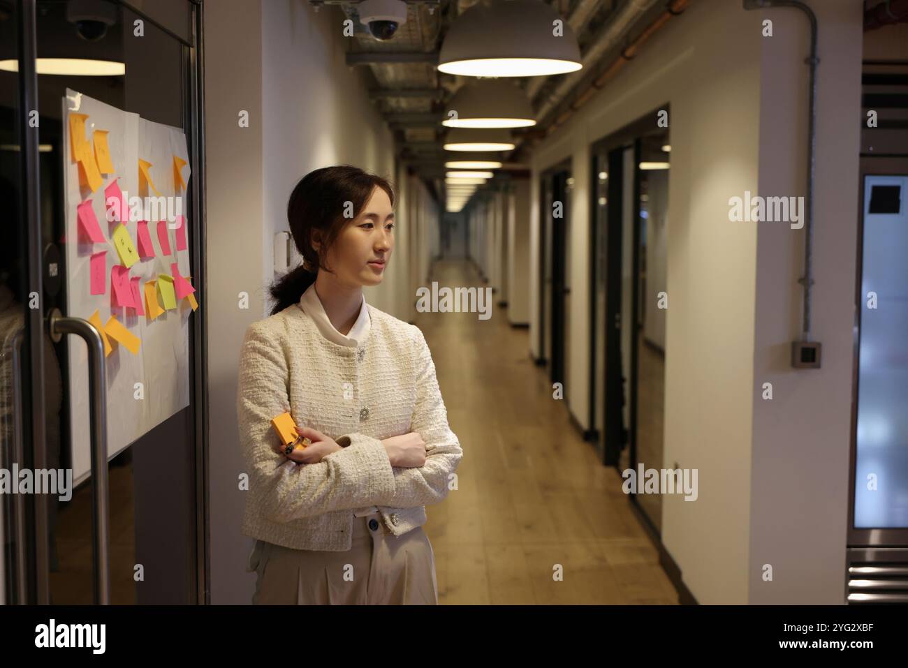 Employee standing at bulletin board Stock Photo - Alamy