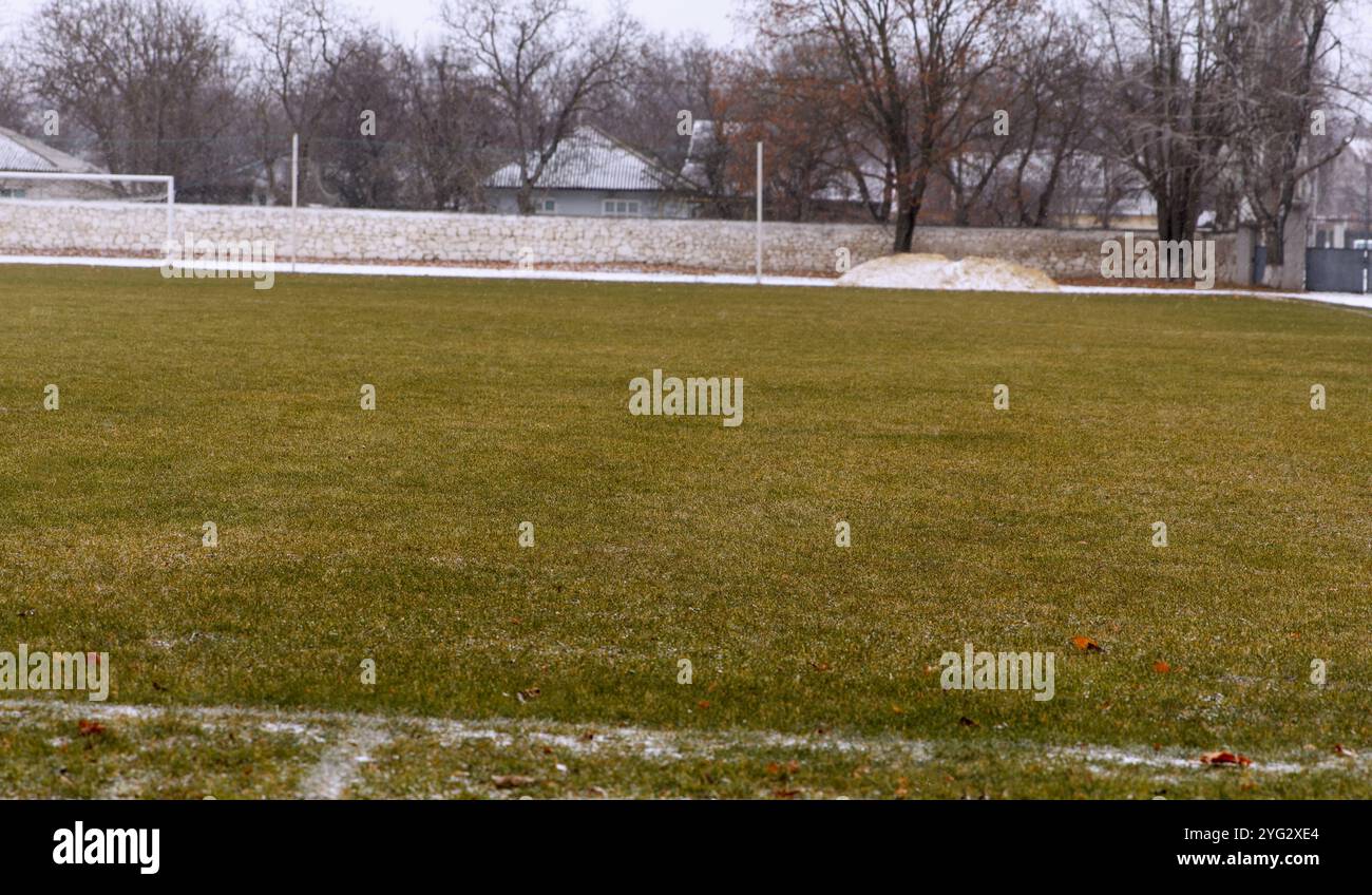 A view of an empty football field covered in grass with gates and ...