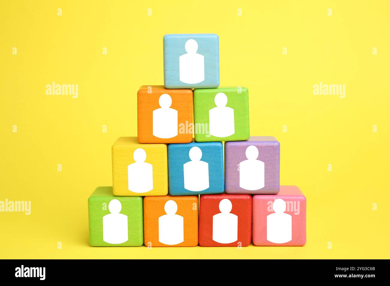 Human resource. Pyramid of colorful cubes with human icons on yellow ...