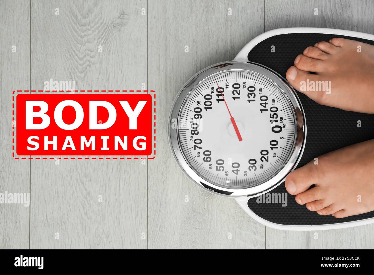 Stop body shaming. Woman standing on scales indoors, top view Stock ...