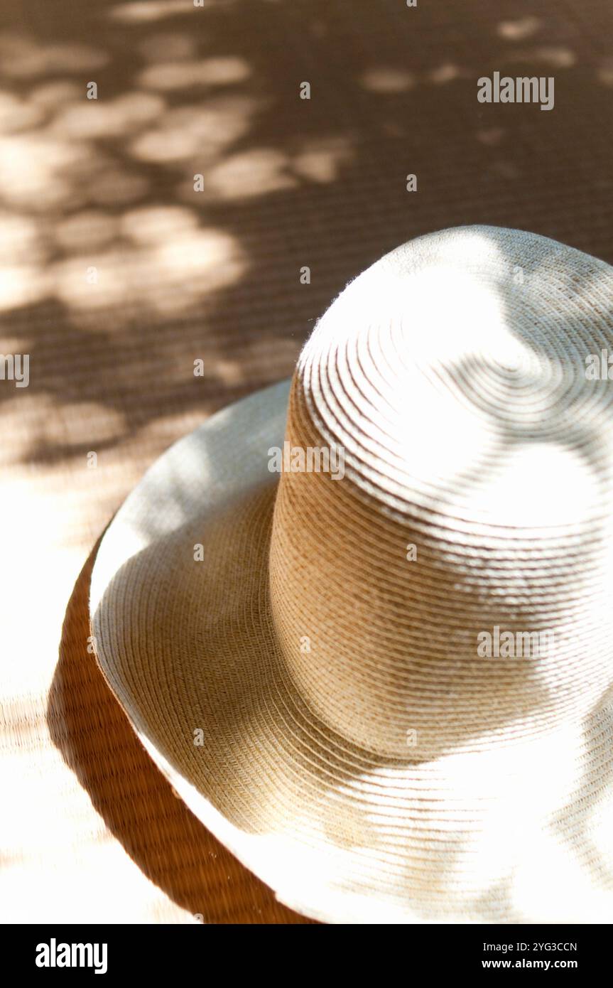 Shadow of tree falling on straw hat Stock Photo - Alamy
