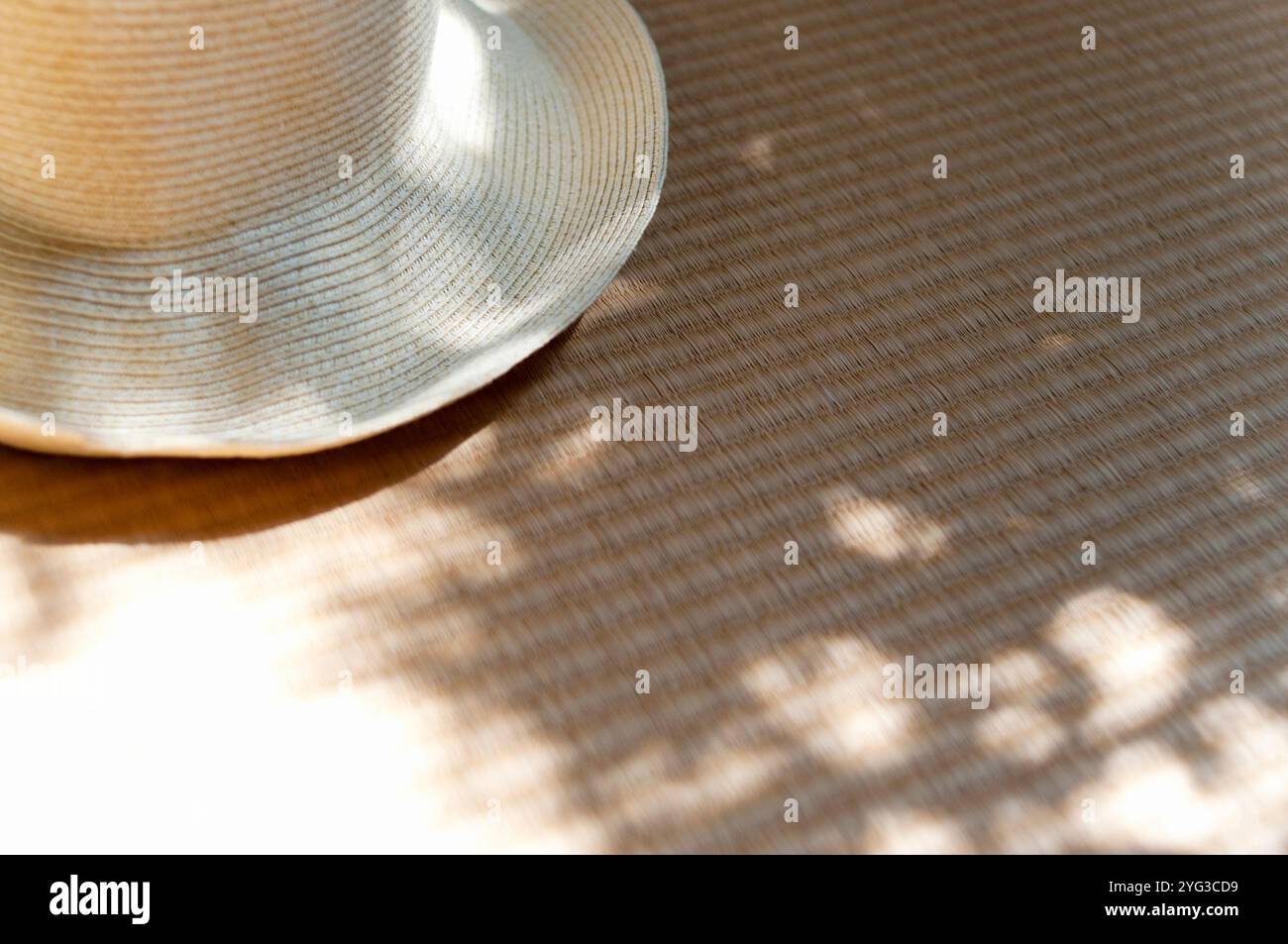 Shadow of tree falling on straw hat Stock Photo - Alamy