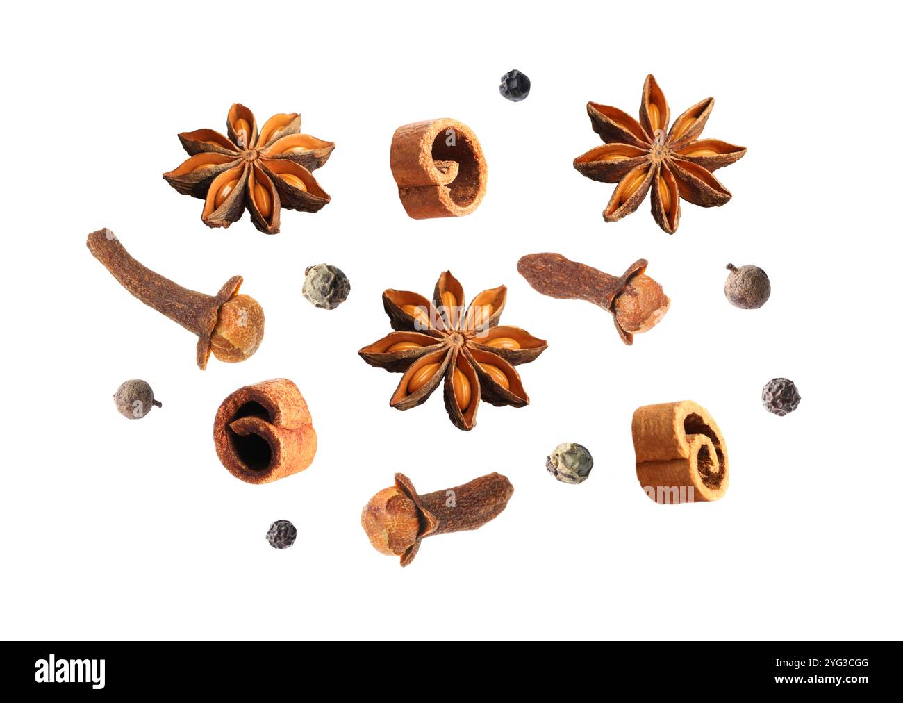 Cloves, cinnamon, anise and mix of peppers in air on white background ...