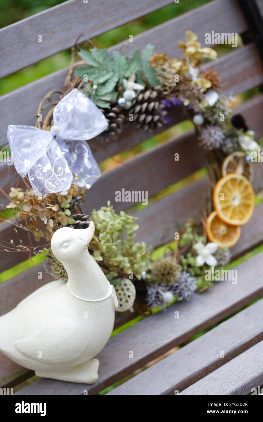 Wreath and white duck object on the bench Stock Photo - Alamy