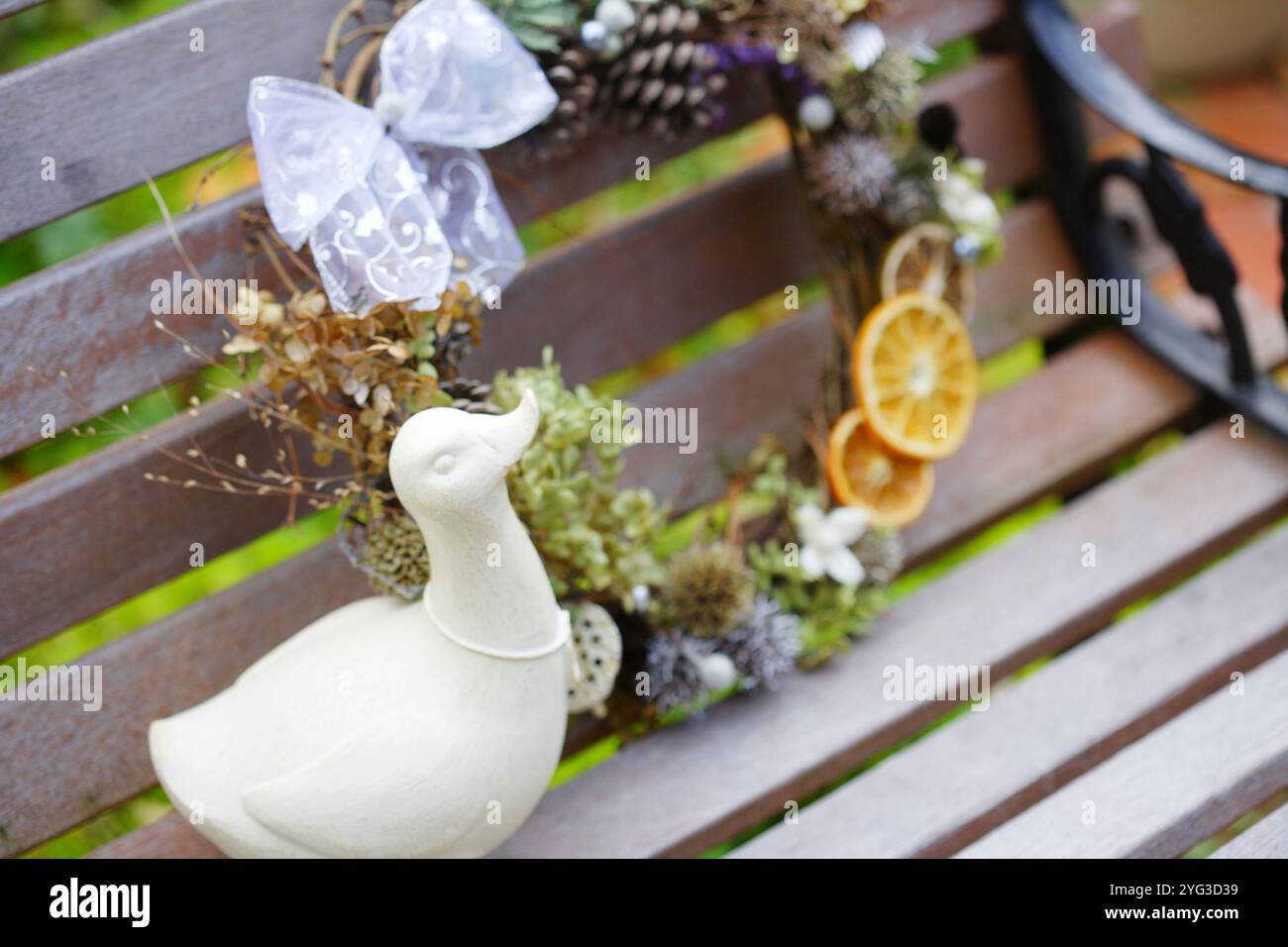 Wreath and white duck object on the bench Stock Photo - Alamy