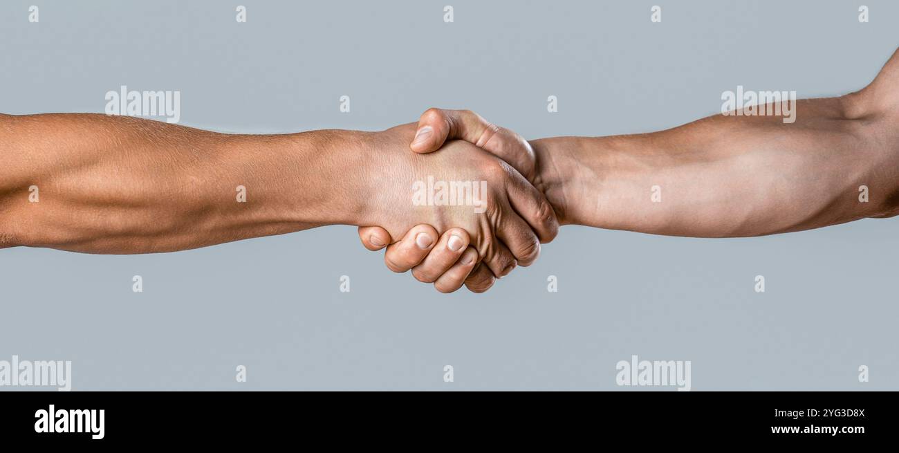 Friendly handshake, friends greeting, teamwork, friendship. Close-up. Rescue, helping gesture or ...