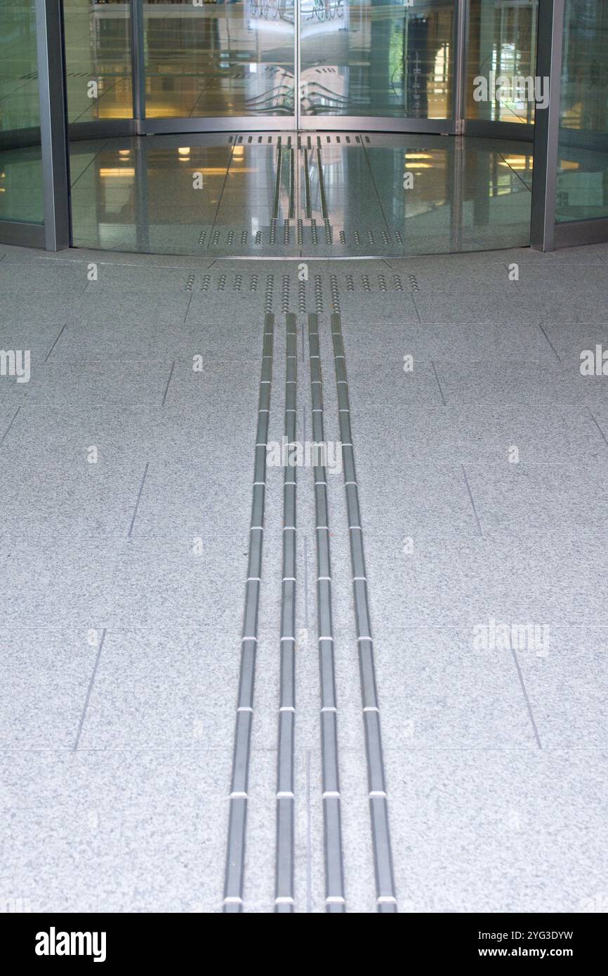 Entrance door and Braille block in office building Stock Photo - Alamy