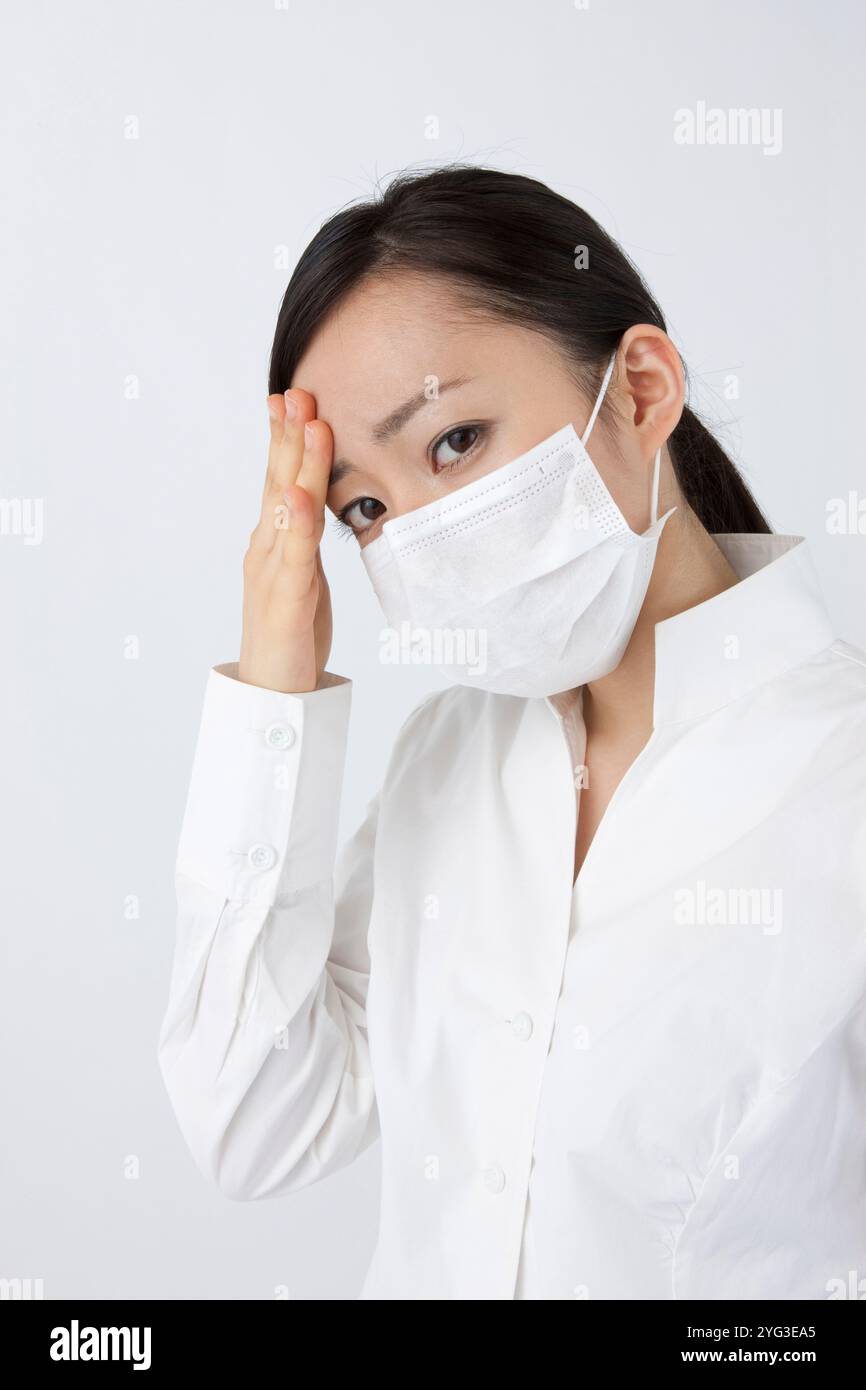Woman holding head down Stock Photo - Alamy