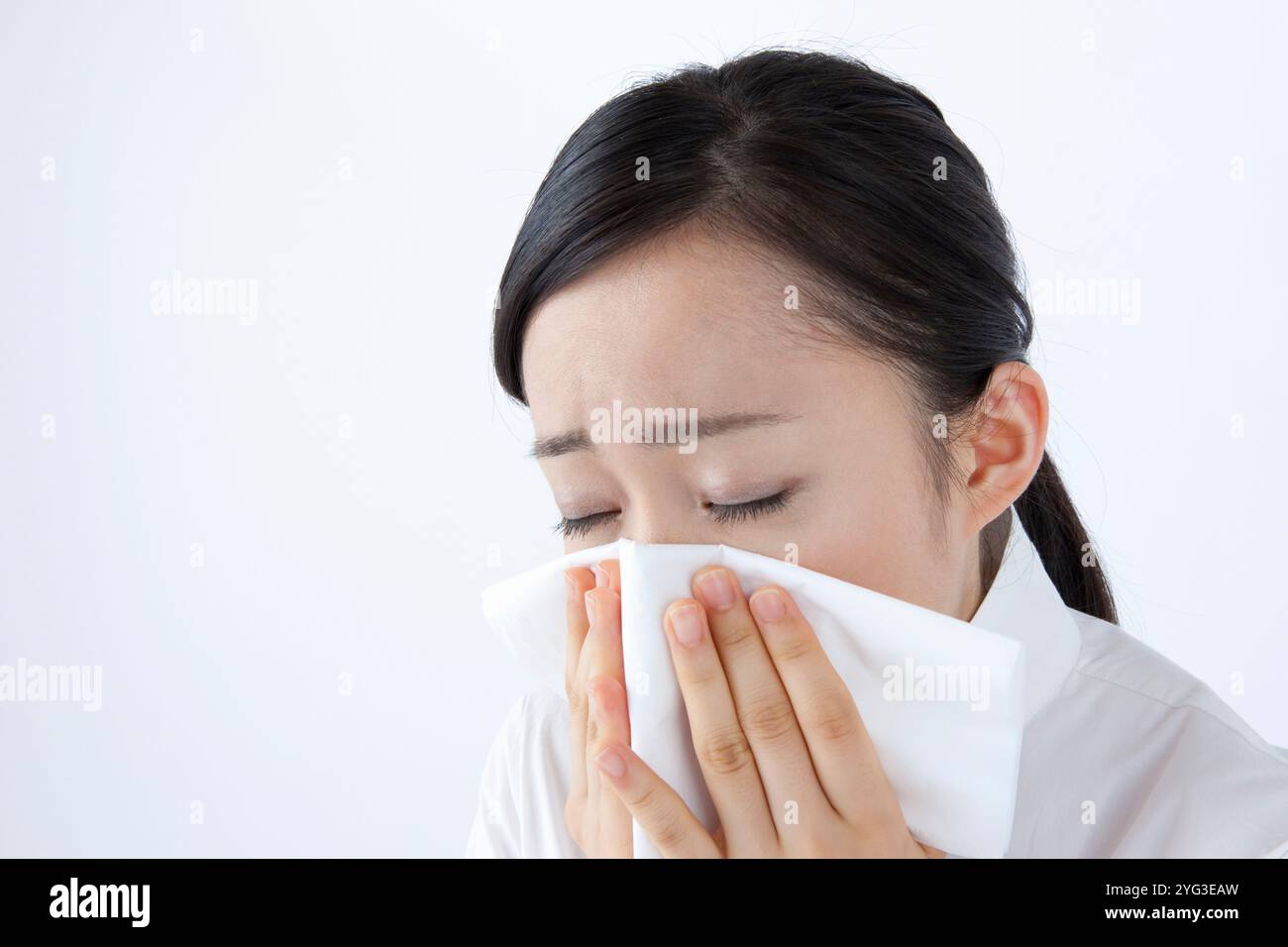Woman biting her nose Stock Photo - Alamy
