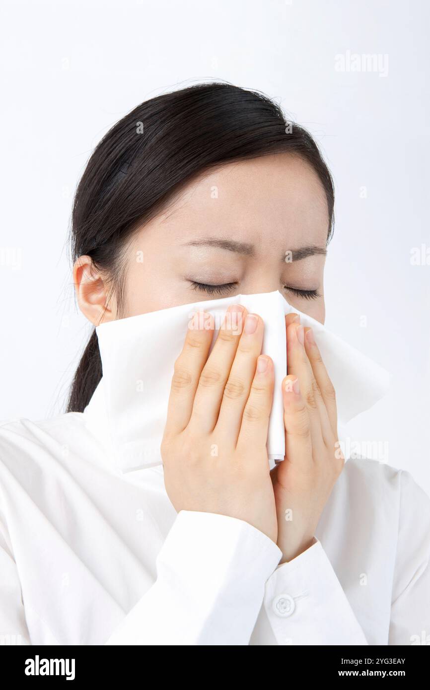 Woman biting her nose Stock Photo - Alamy