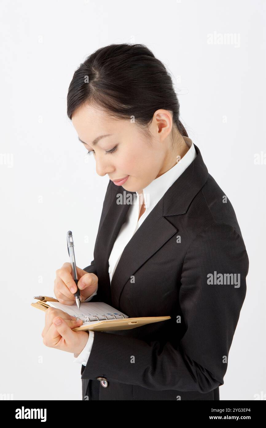 Office worker writing a schedule Stock Photo - Alamy