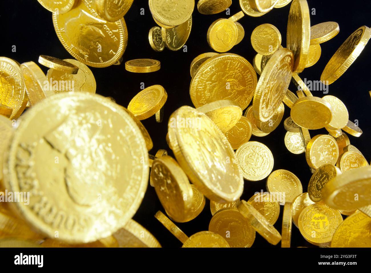 Flying gold coins Stock Photo - Alamy