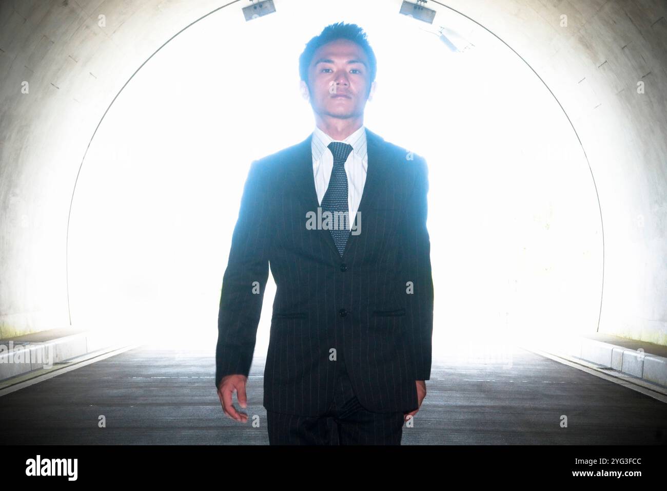 Business people walking through tunnel hi-res stock photography and ...
