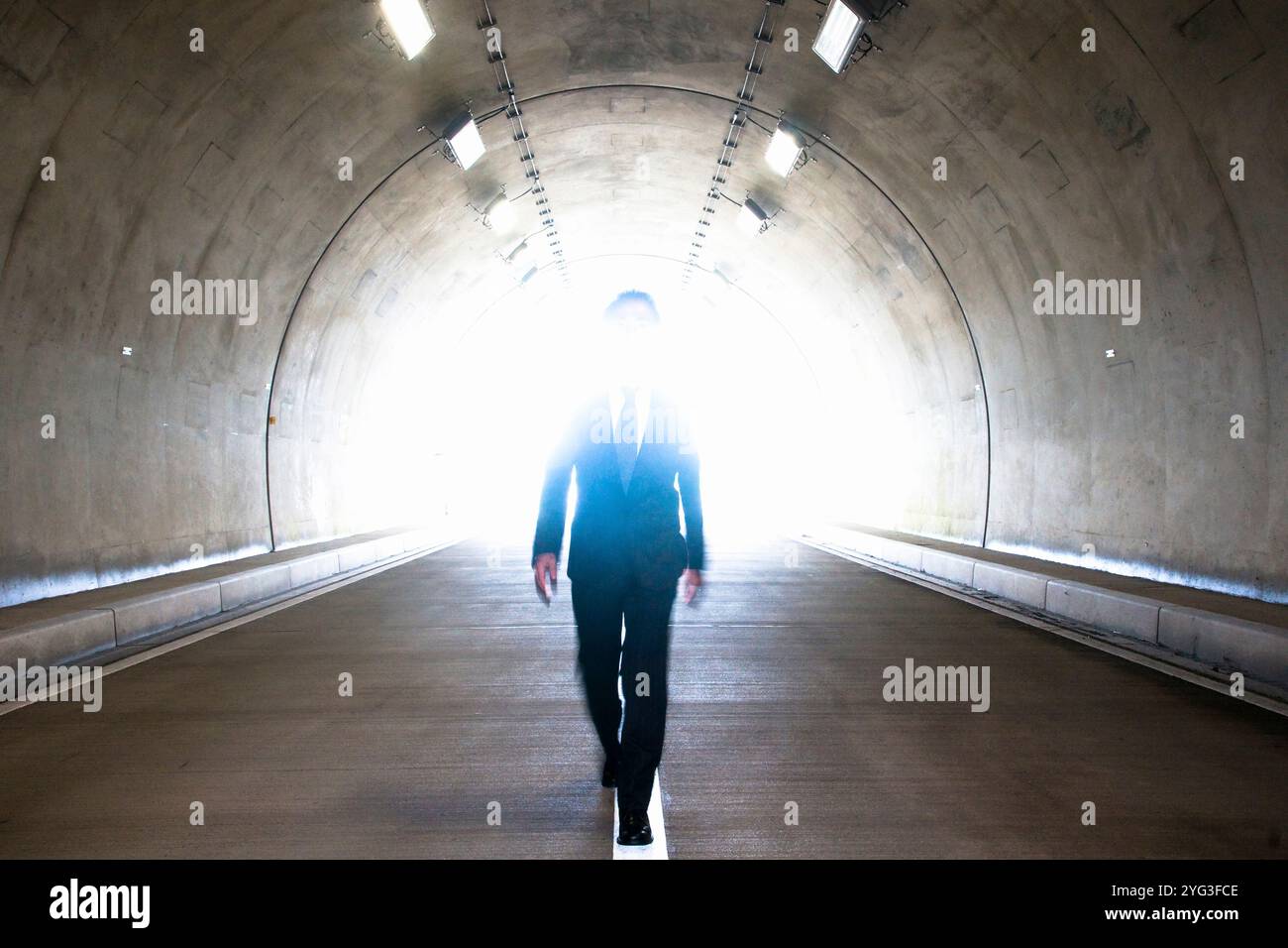 Business people walking through tunnel hi-res stock photography and ...