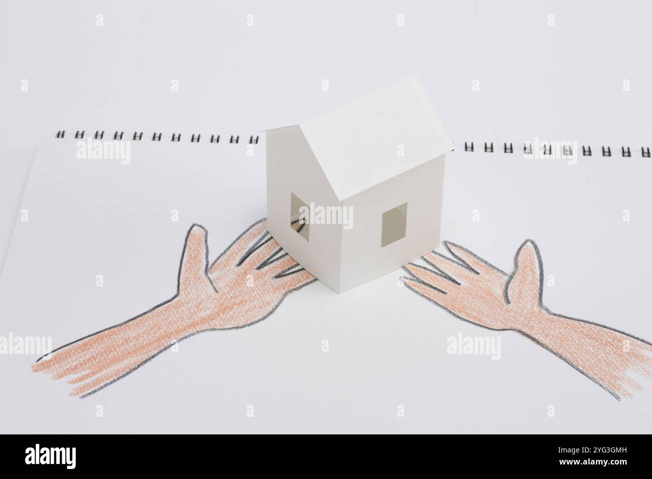 Paper craft house and illustration hand Stock Photo - Alamy