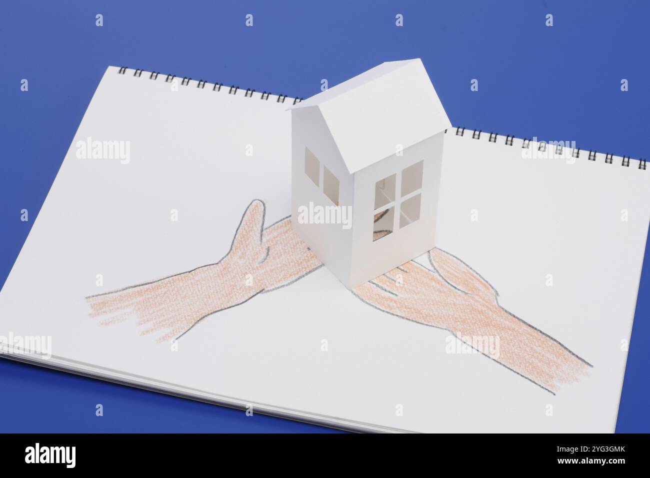 Paper craft house and illustration hand Stock Photo - Alamy