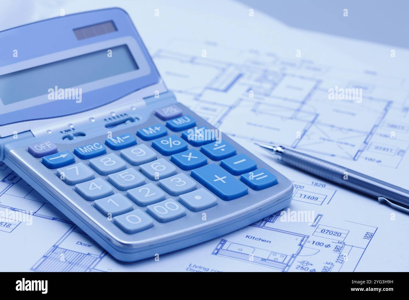 Blueprints, calculator and pen Stock Photo - Alamy