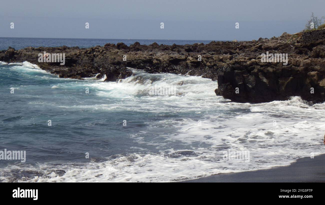 Rocky Ocean Shoreline With Crashing Waves and Blue Sky Stock Photo - Alamy