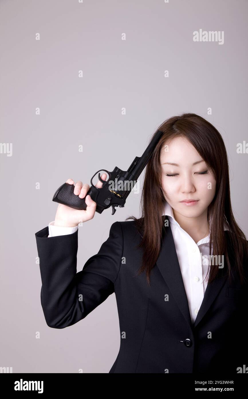 Woman with revolver-type gun Stock Photo - Alamy