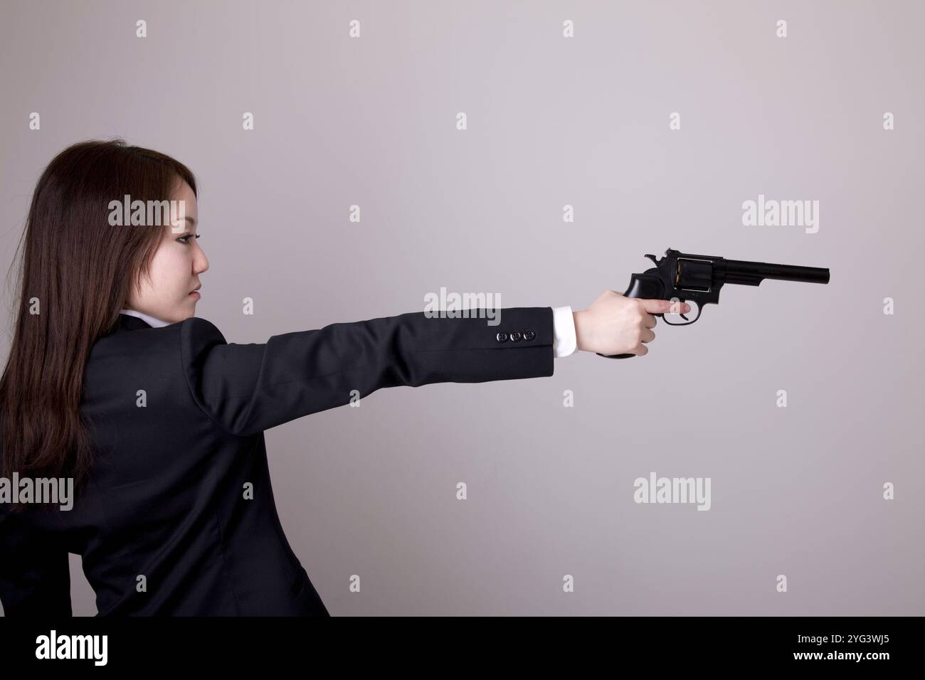 Woman with revolver-type gun Stock Photo - Alamy