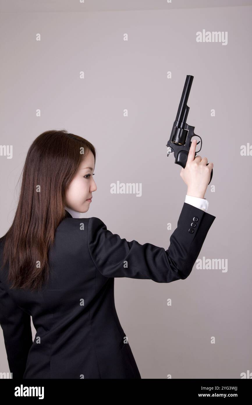 Woman with revolver-type gun Stock Photo - Alamy